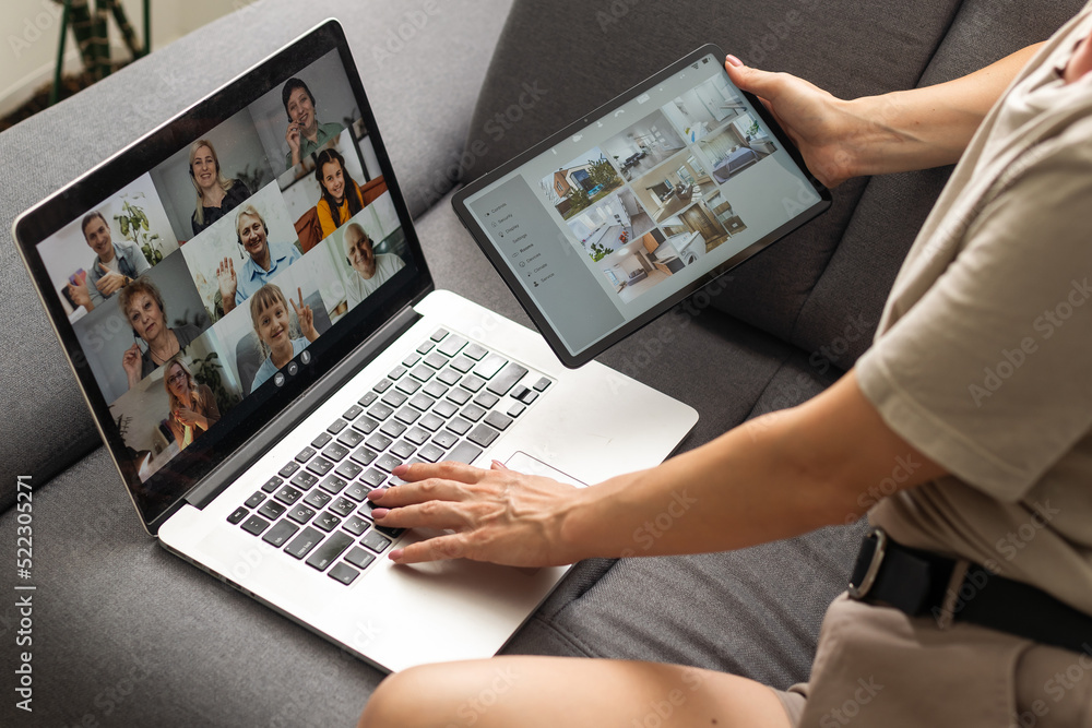 Young woman enjoying video conversation via laptop with eldery mother ...