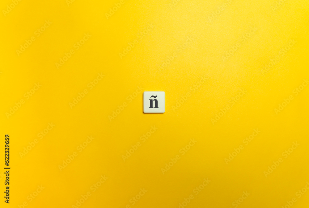 Tilde Diacritical Mark on Letter Tile on Yellow Background. Minimal ...