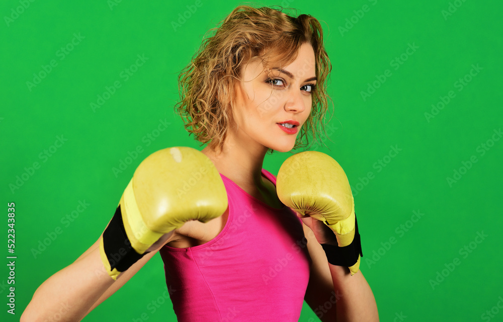 Sporty girl in boxing gloves training at fitness center. Boxer MMA ...