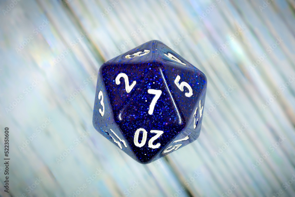 Lucky number seven on a sparkly blue twenty-sided adventure game die ...