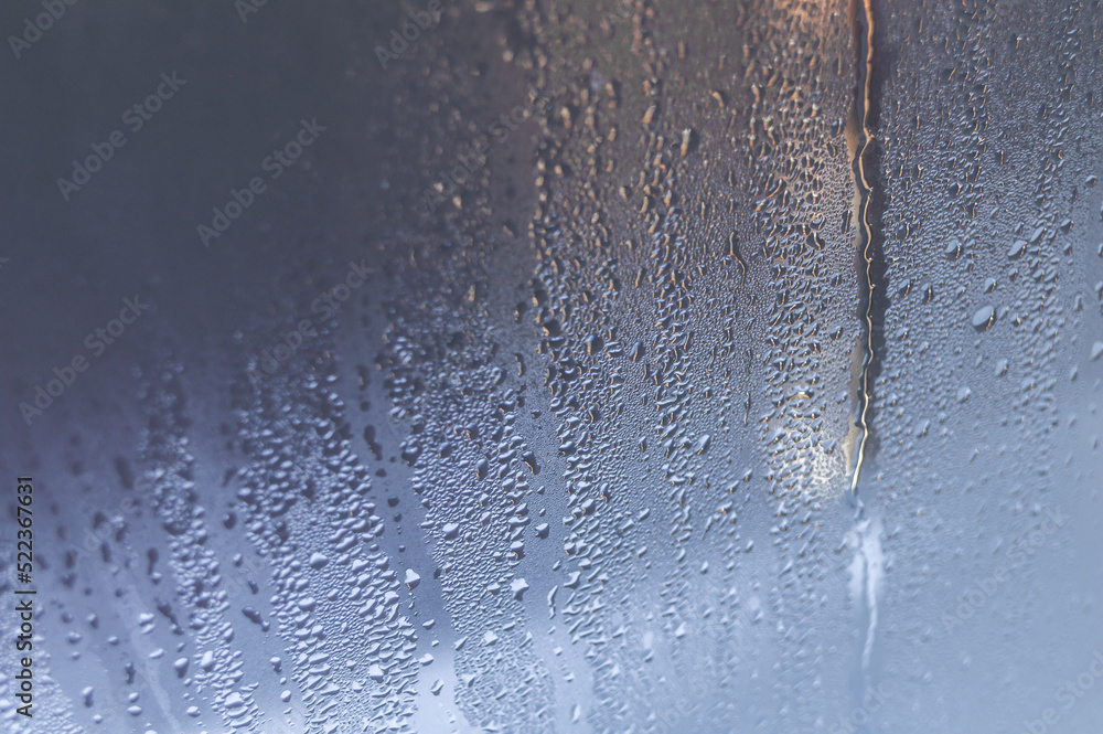 Condensate drops on the glass of a plastic window. Freezing and the ...