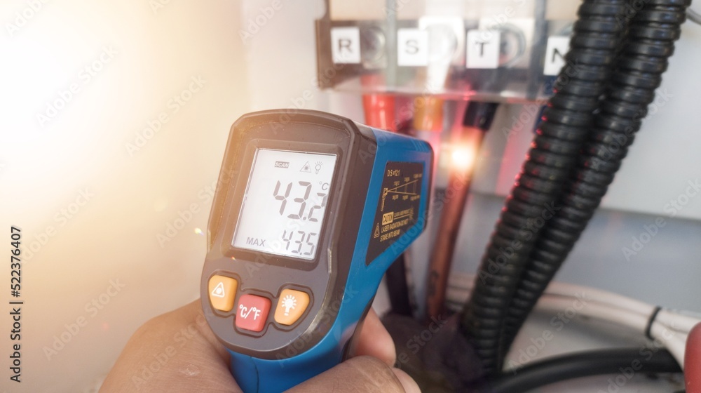 Photo & Art Print an electrician is using a thermogun to analyze sub ...
