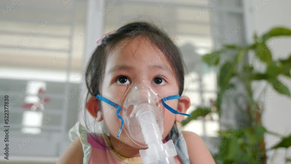 Kid girl making makes inhalation nebulizer steam sick cough at home ...