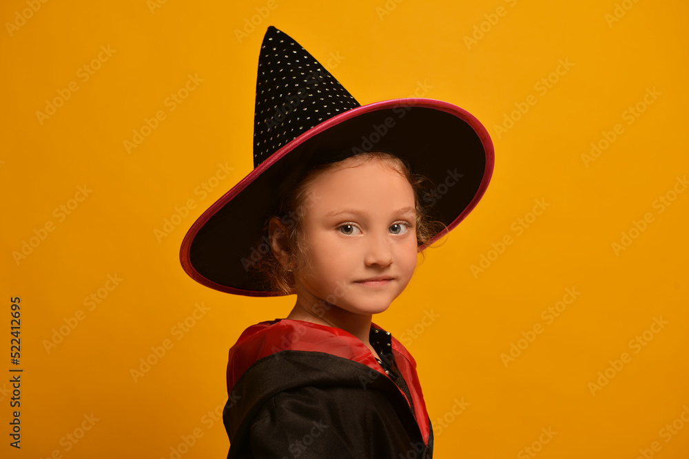 Portrait of cute little wizard girl wearing Halloween costume on a ...