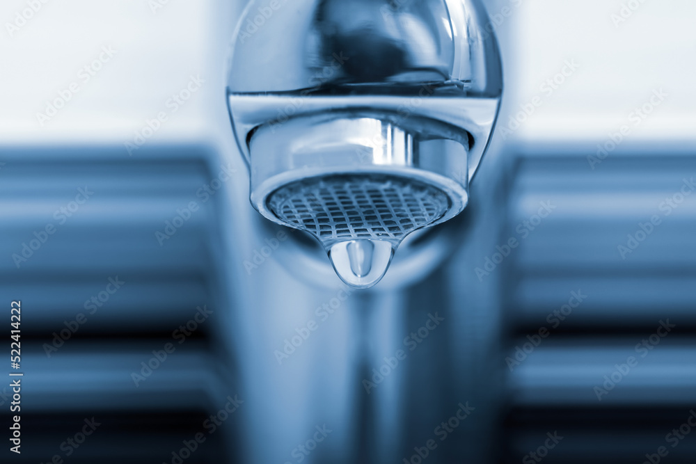 Water drop falling down from tap on blurred background, closeup Stock ...