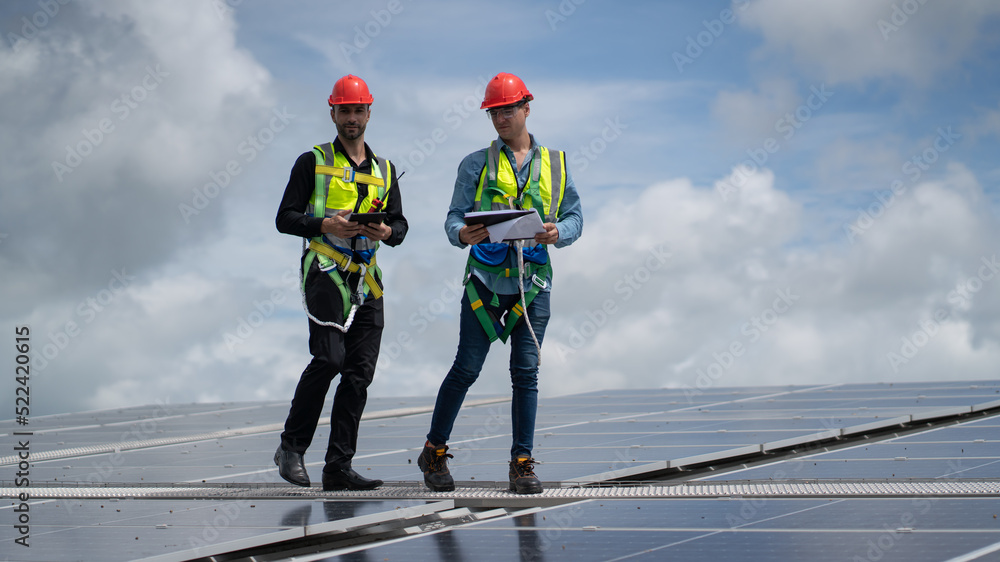 Construction workers clean solar panels for energy.Renewable Energy ...