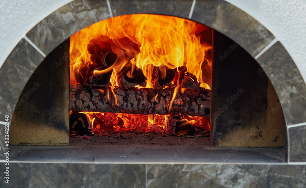 Burning firewood in fire-box of fireplace in country cottage. Rustic ...