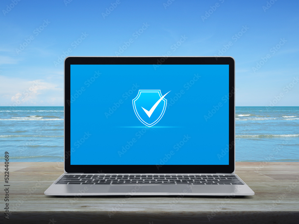 Security shield with check mark icon on modern laptop computer monitor ...