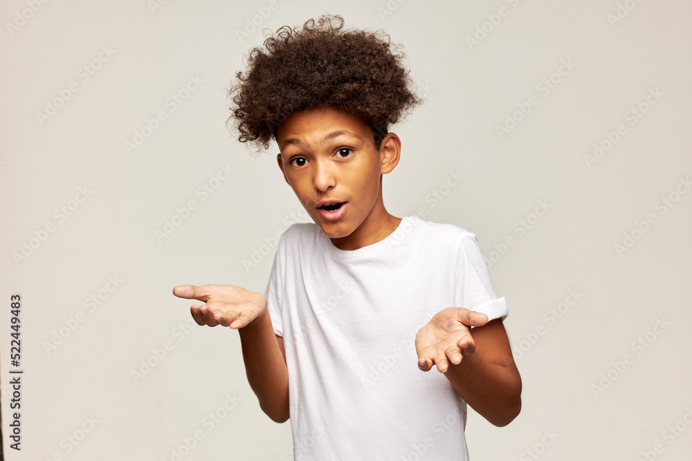 Puzzled and clueless african american boy kid with afro hairstyle ...
