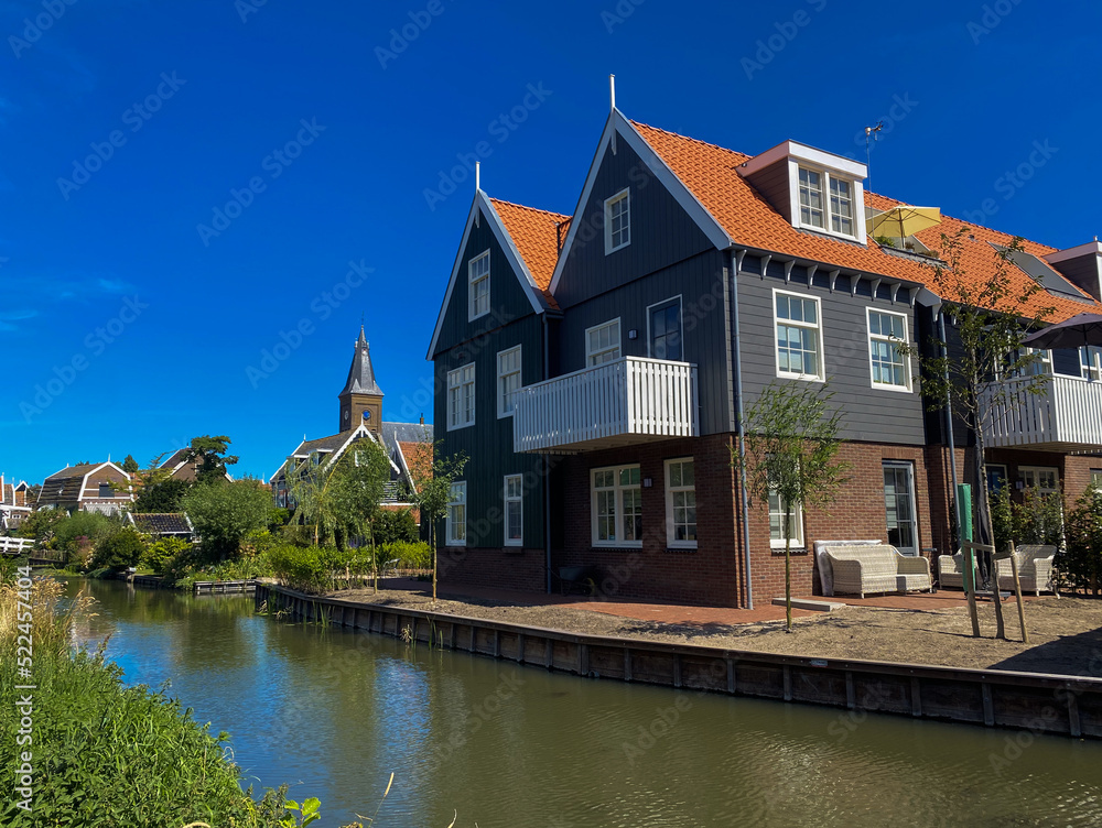 Dutch village scene with wooden houses over canal on the island of ...