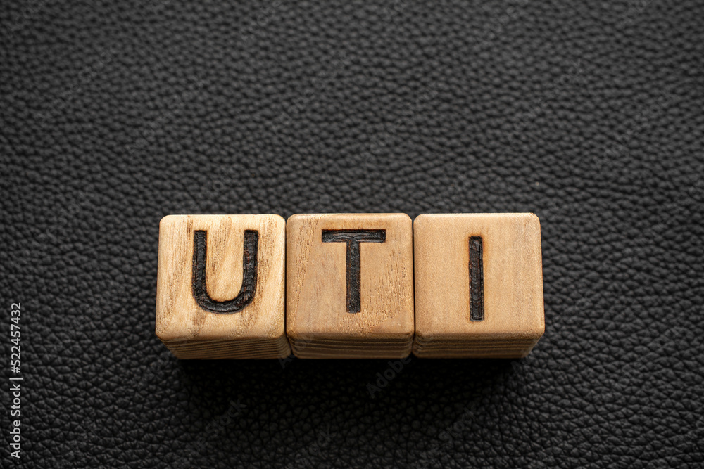 UTI - acronym from wooden blocks with letters, abbreviation UTI urinary ...