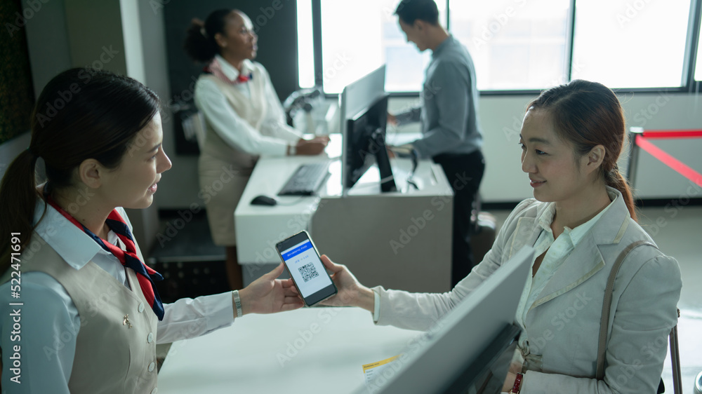Passengers at check in counter. businesswoman in suit holding his ...