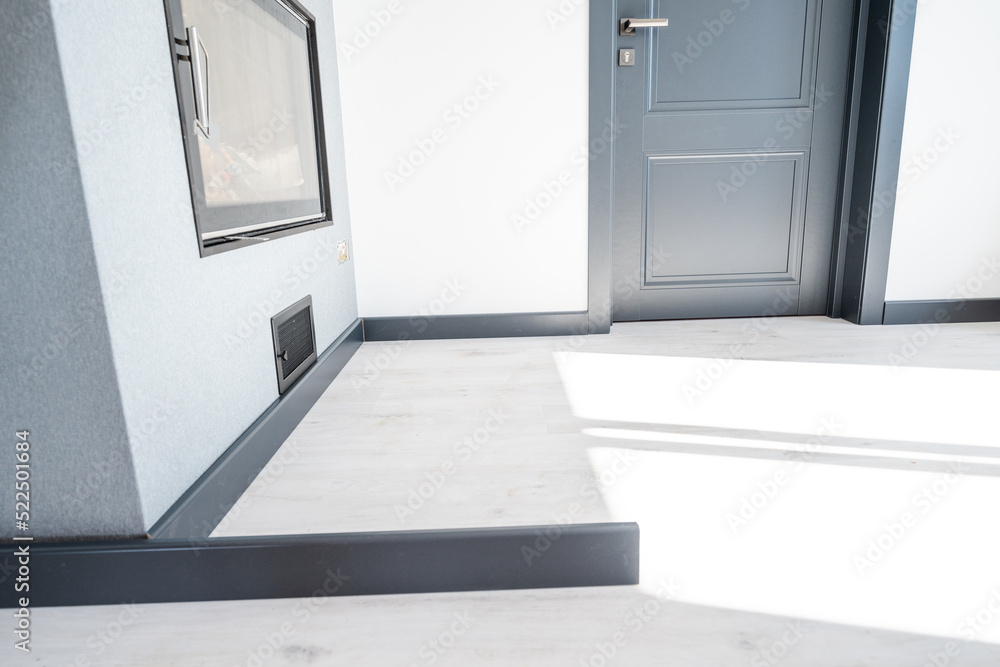 The plinth is dark gray to match the color of the door, mounting the ...