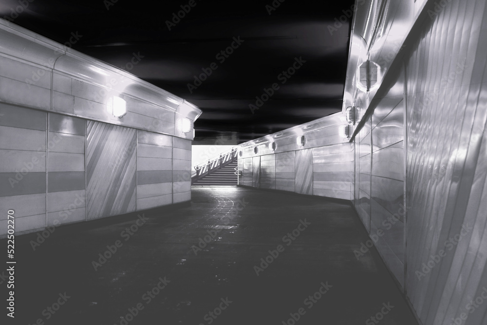 Underground pedestrian crossing. A dark path to light. Geometry of ...