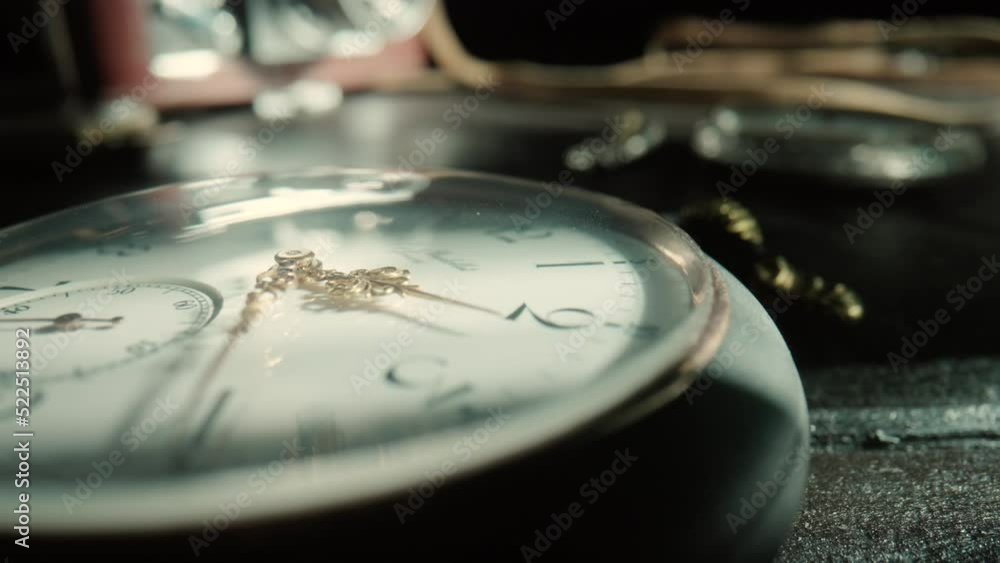 Silver antique pocket watch with ticking gold hands and vintage camera ...