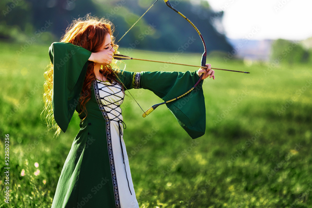 mysterious red-haired warrior girl stands. Lady elven princess holds ...