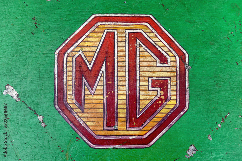 Vintage MG motor sign hand painted onto a metal plate background. Red ...