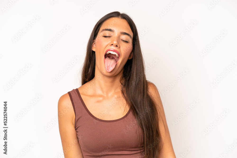 hispanic pretty woman with cheerful, carefree, rebellious attitude, joking and sticking tongue ...
