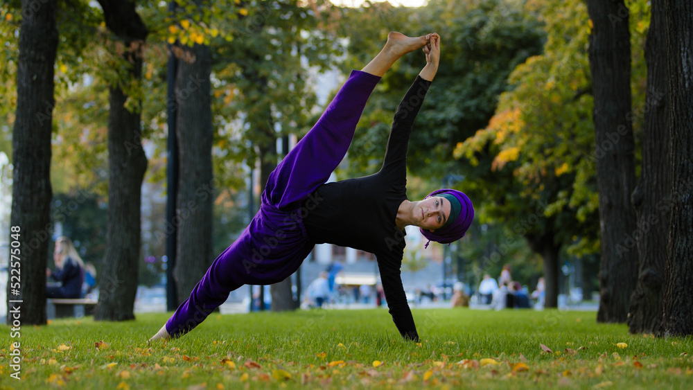 Strong sportive islamic girl in hijab yoga teacher woman stands in side ...