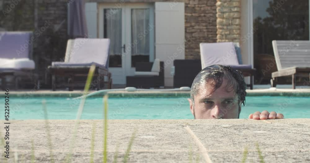 Bearded man swimming underwater in swimming pool at luxury hotel spa ...