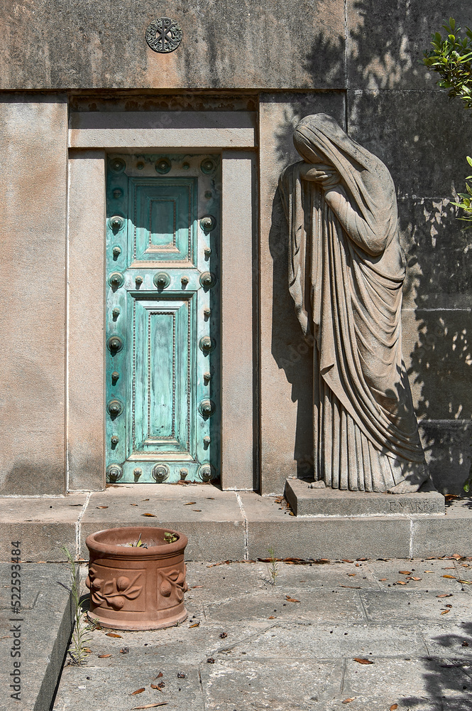 Entrance door to the crypt of the dead, with a large figure ensota ...