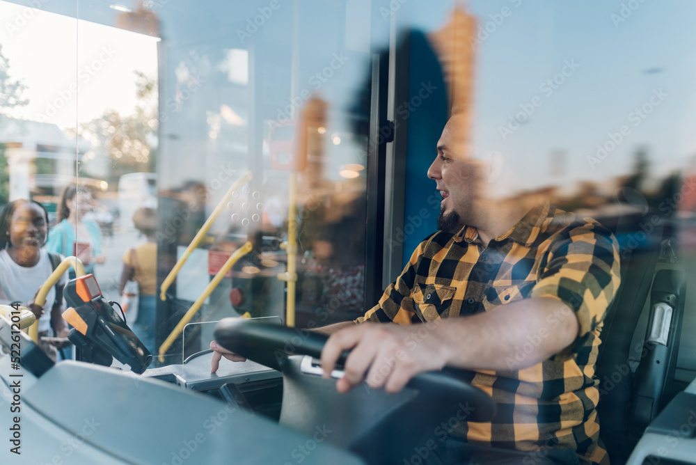 Bus driver behind the wheel of a public transport vehicle 스톡 사진 | Adobe ...
