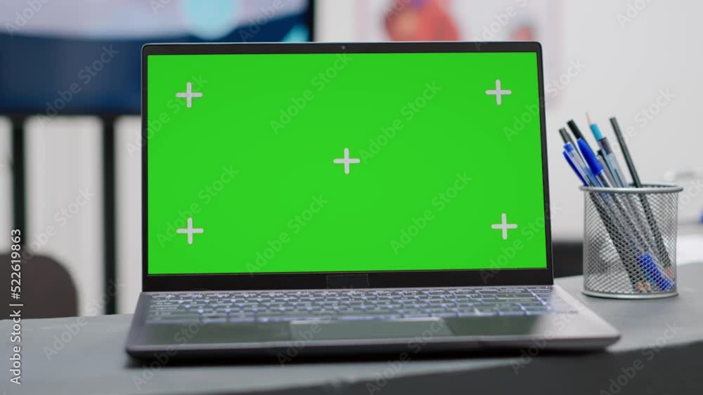 Laptop with greenscreen display on facility reception counter in ...