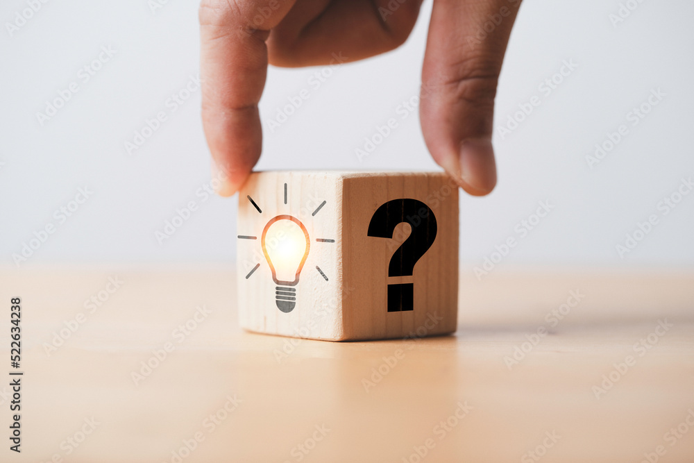 Hand flipping between question mark and glowing lightbulb for question ...