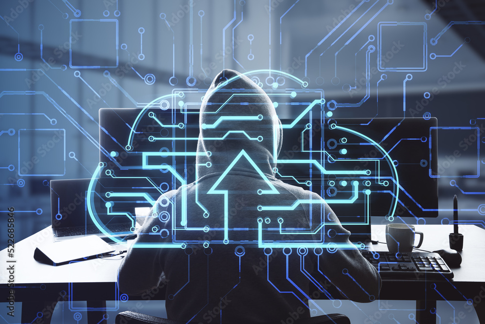 hacker at desktop using laptop computer monitors with abstract glowing ...