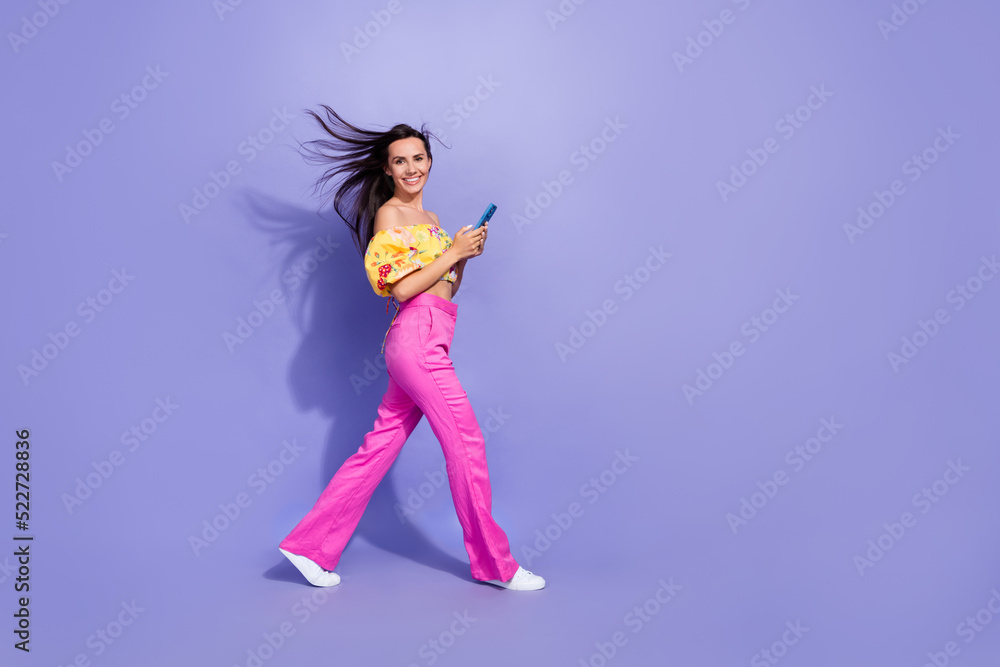 Full body profile portrait of pretty positive lady hold telephone walk ... Full body profile portrait of pretty positive lady hold telephone walk ...