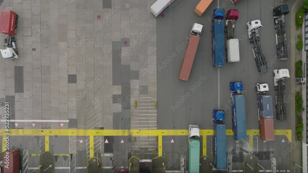 Queue of trucks in logistic site. Birds eye footage of transport ...