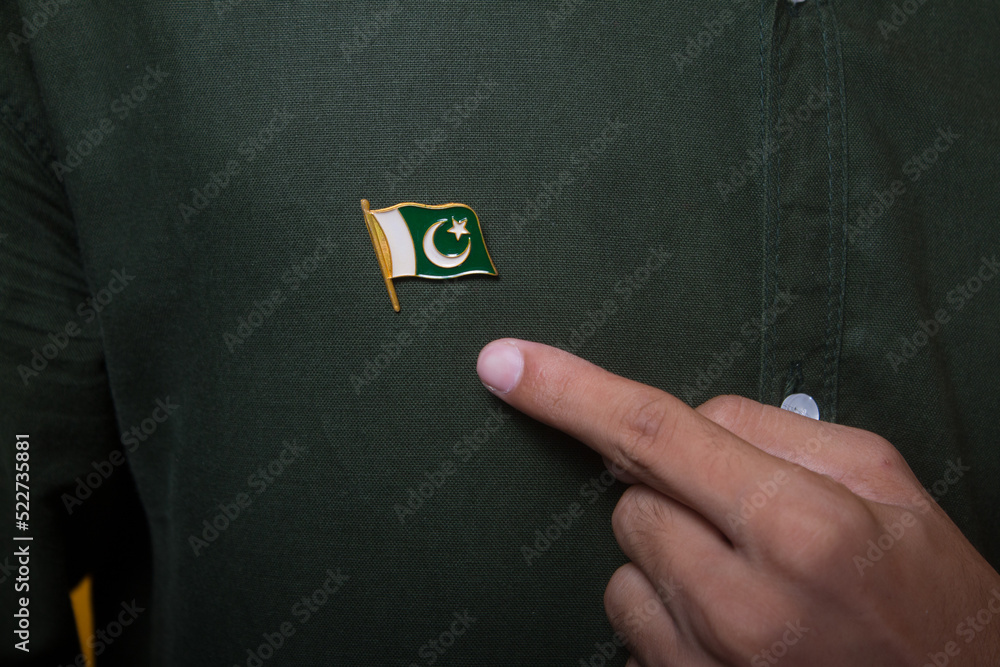 Pakistani flag badge on chest and pointing finger at pakistan flag ...