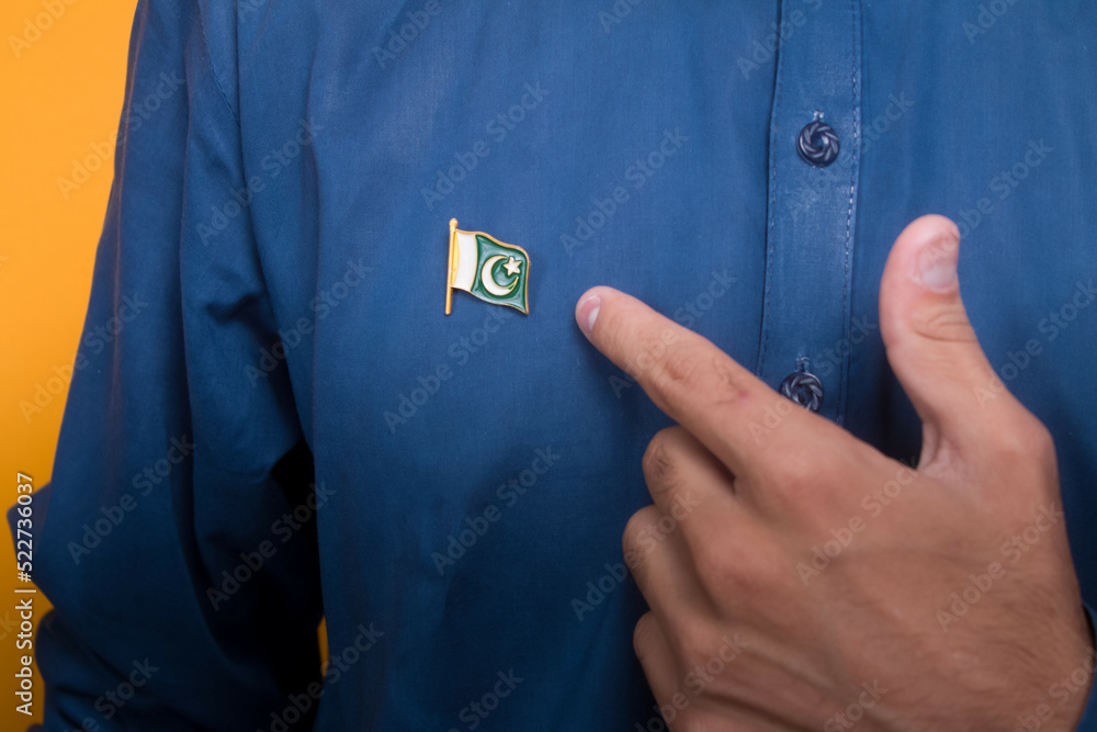 Pakistani Flag Badge On Chest And Pointing Finger At Pakistan Flag