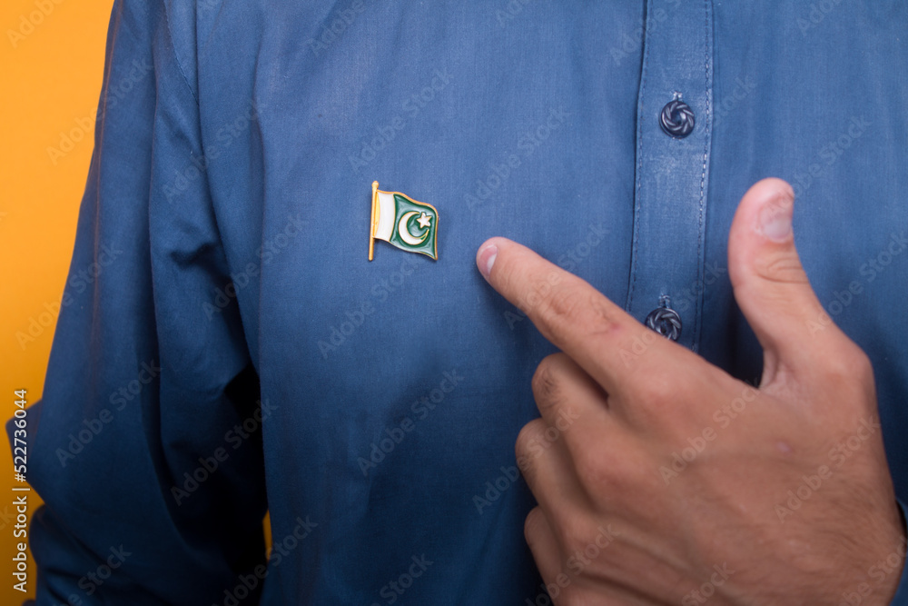 Pakistani flag badge on chest and pointing finger at pakistan flag ...