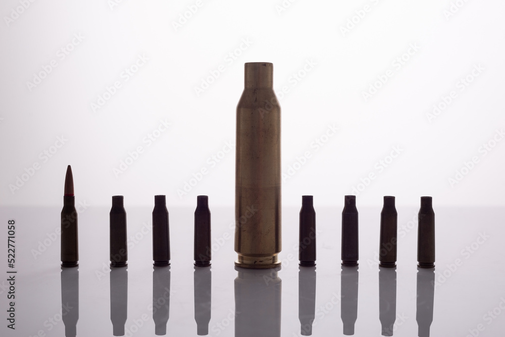 used spent shells of cartridges from a machine gun and a machine gun on ...