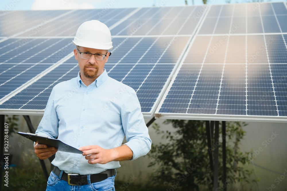 Engineer at solar power station with solar panel. Practical lessons on ...