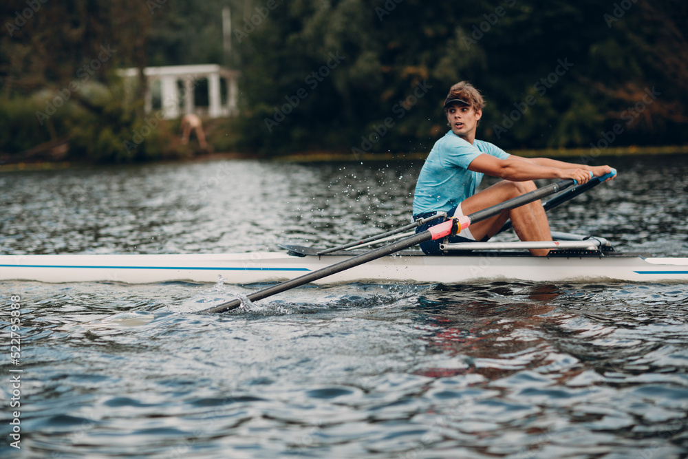 Sportsman athlete single scull man rower rowing technique on boat ...