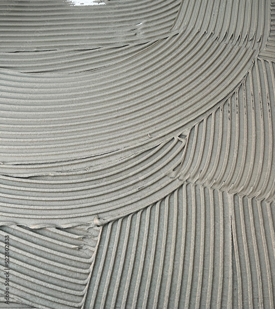 cementitious adhesive applied to the floor ready to receive the ceramic ...