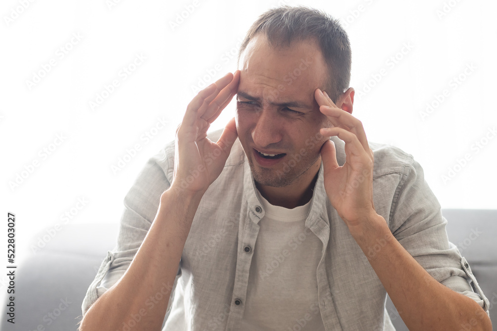 Exhausted Caucasian millennial male worker take off glasses massage ...
