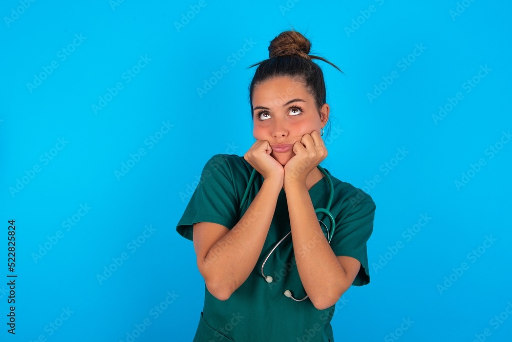 Portrait of sad beautiful doctor woman wearing medical uniform over ...