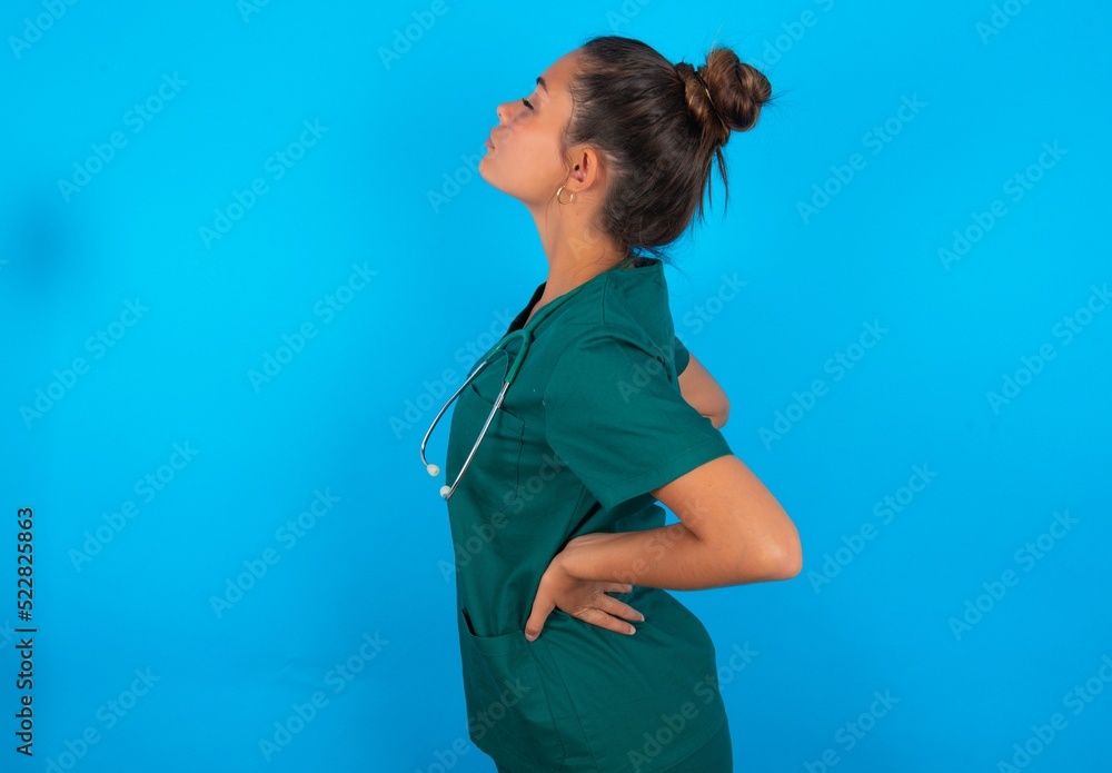 beautiful doctor woman wearing medical uniform over blue background got ...