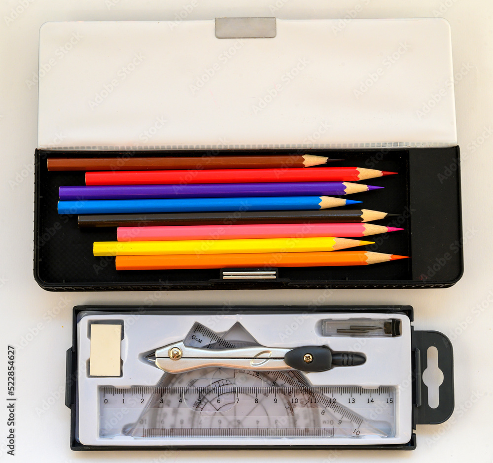 pencil case with colored graphite pencils and a drawer with compasses ...