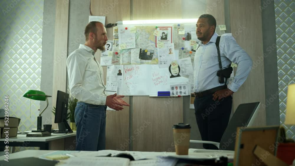 Diverse detectives emotionally discussing a hard investigation in ...