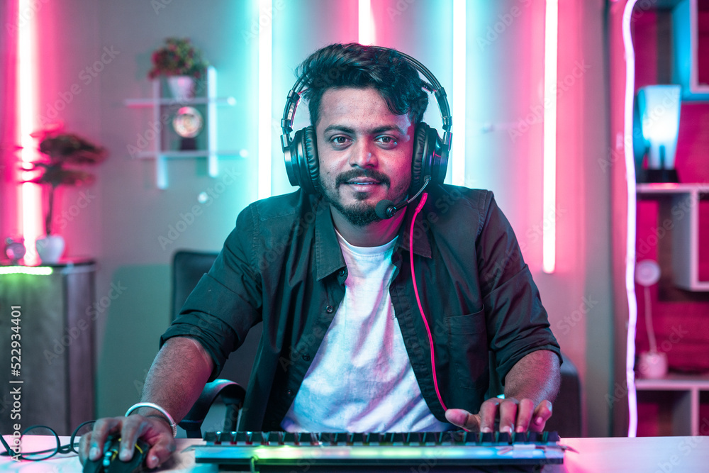 Excited gamer with headphones playing online video game by looking ...