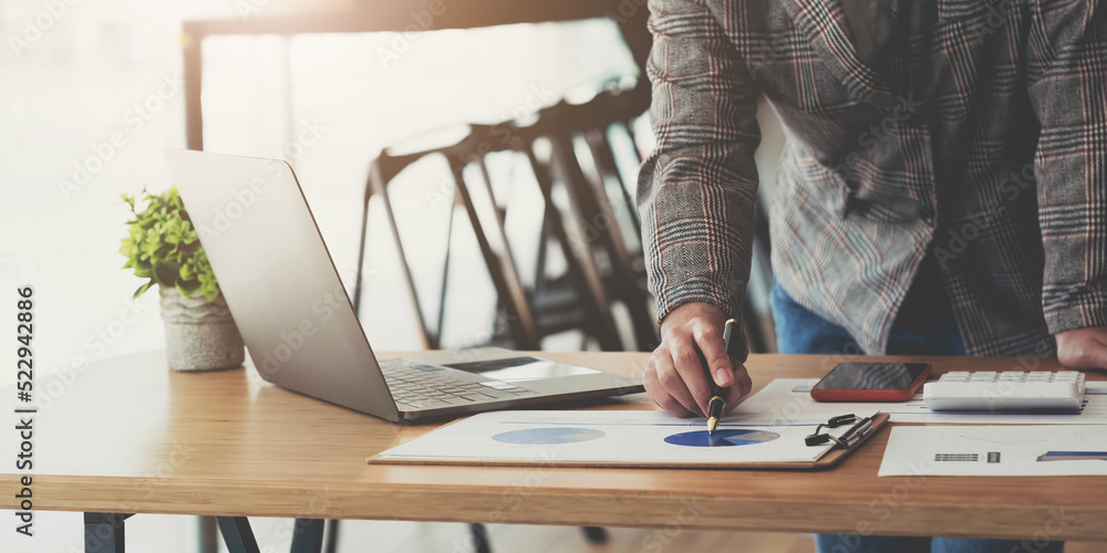 Business people or accountants are analyzing graphs on finance ...