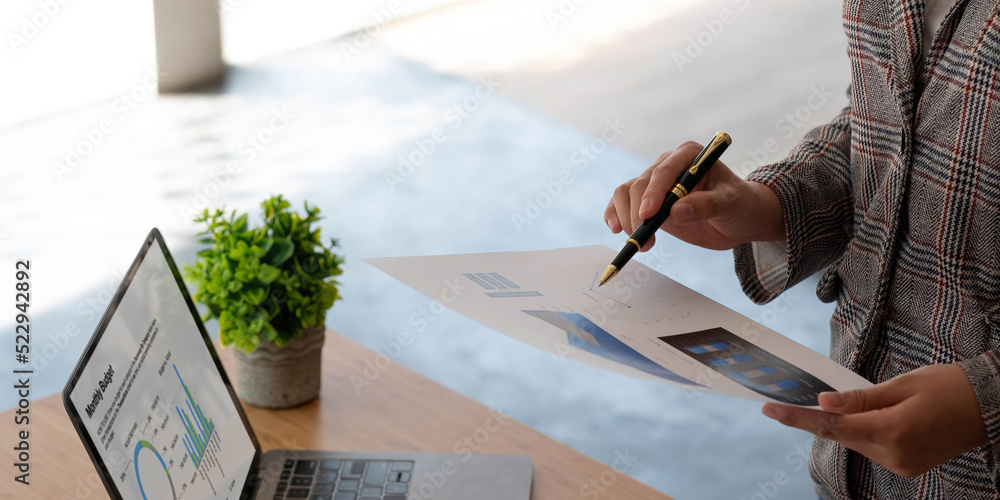 Closeup business people or accountants are analyzing graphs on finance ...