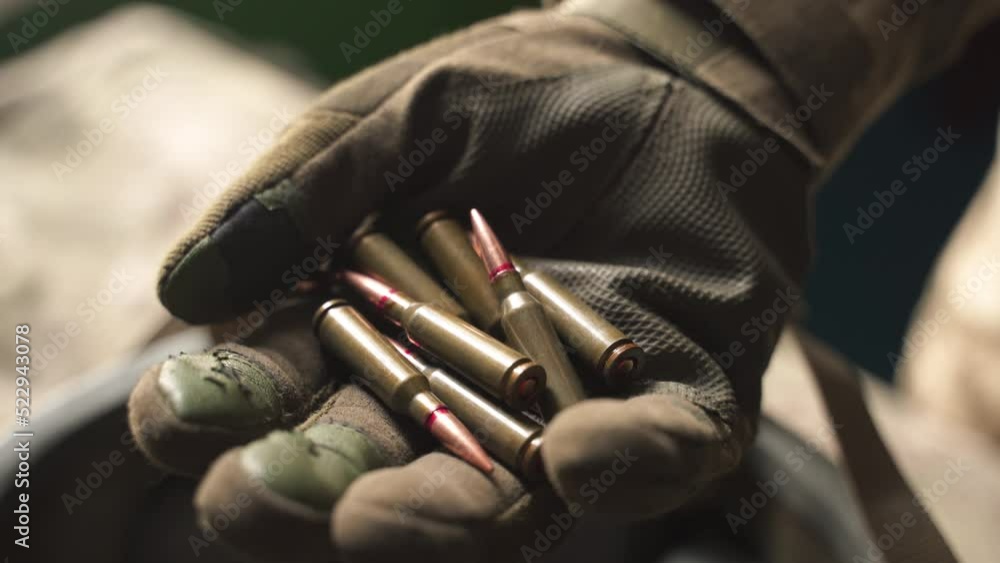 soldier holds bullets from his machine gun in his fist. old tactical ...