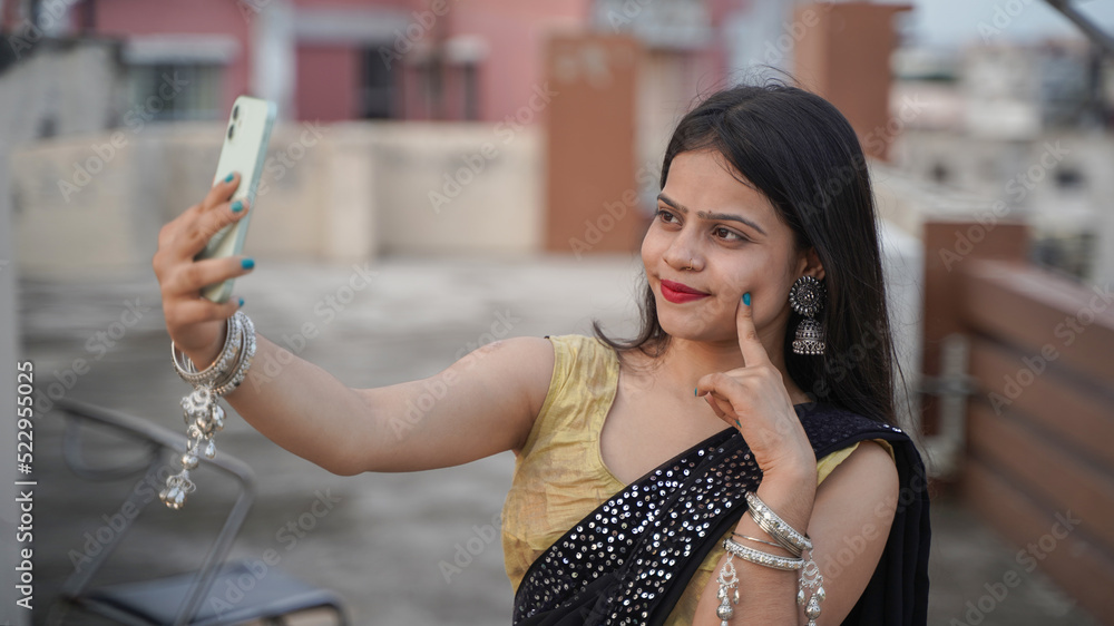Beautiful Indian girl taking selfie on her mobile phone outdoor ...