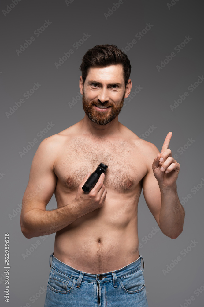happy and shirtless man shaving hair on chest with electric razor and ...