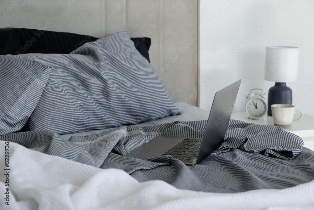 Laptop on a king sized bed with headboard, perfectly clean and ironed ...